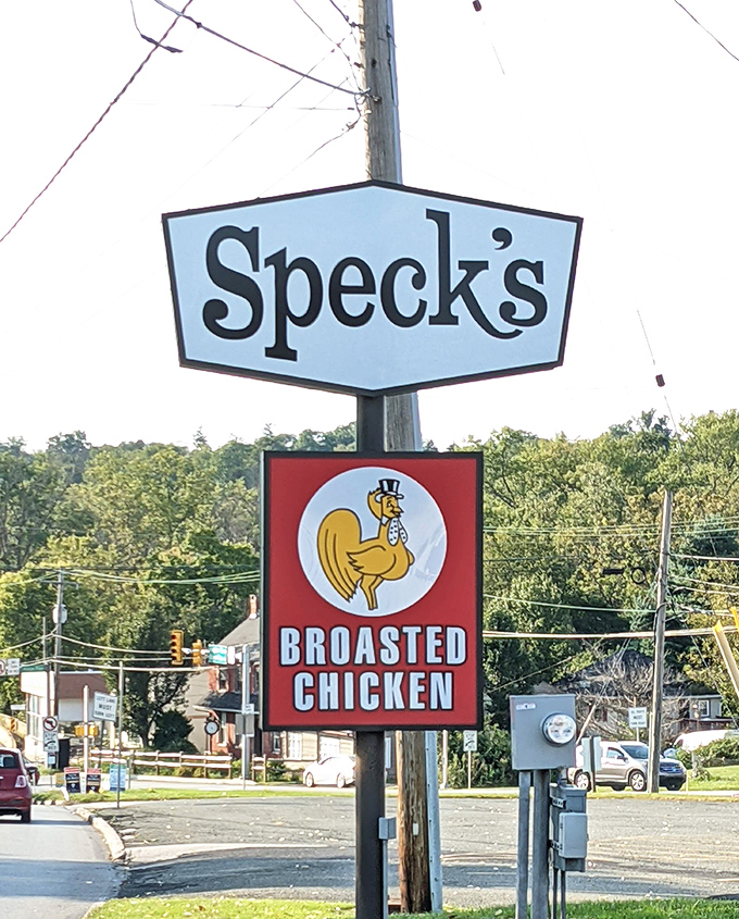 The Speck's sign stands tall like a culinary landmark, complete with a dapper chicken mascot who knows he's representing Pennsylvania's broasted best.