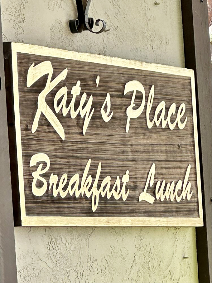 The wooden sign promises breakfast and lunch, but locals know it's really offering happiness served on plates instead of platitudes.