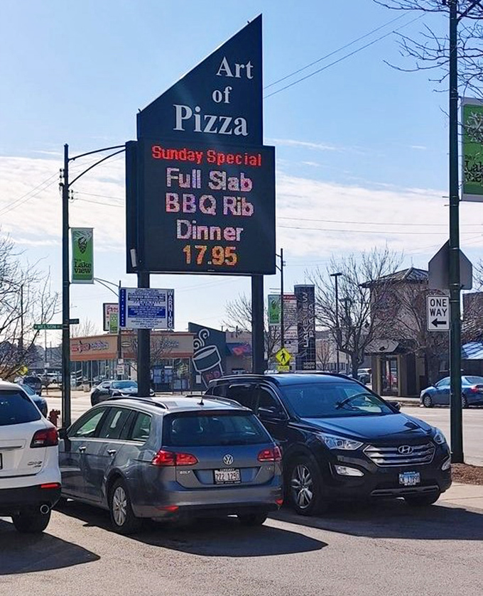 The roadside sign announces BBQ ribs like a plot twist in your pizza narrative. In Chicago, even pizza joints refuse to be typecast.