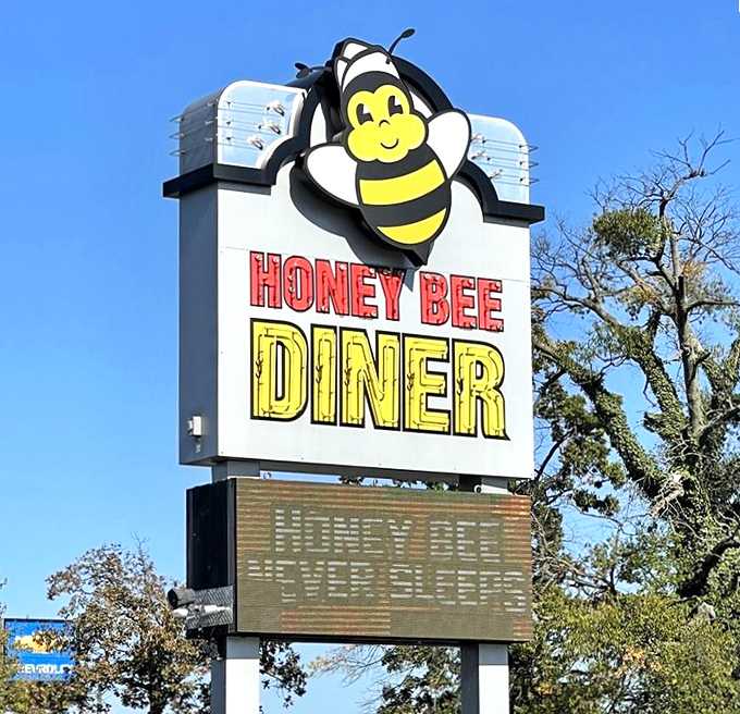 The smiling bee mascot stands guard over Ritchie Highway, a beacon of hope for hungry travelers seeking pancake salvation.