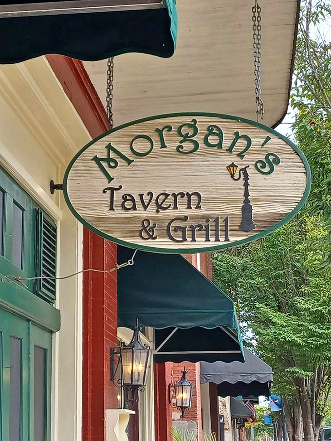 The sign swings gently in the coastal breeze, a wooden invitation to one of New Bern's most beloved culinary destinations.