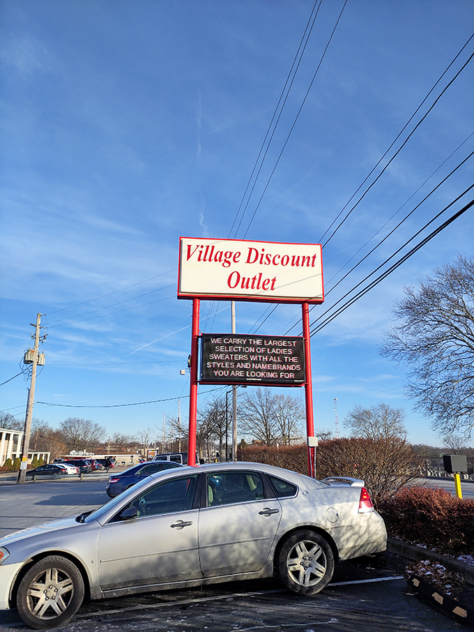 The roadside beacon of bargains announces itself to passing traffic, promising sweater salvation to all who heed its call.