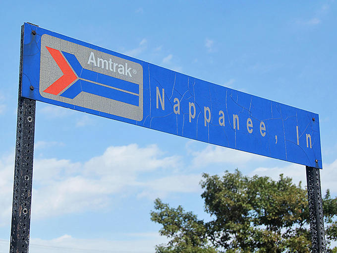The weathered Amtrak sign stands as both invitation and promise&mdash;Nappanee may be small, but it's connected to the wider world.