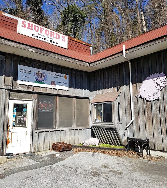 The weathered wooden exterior with its cartoon pig sign signals exactly what you're in for—unpretentious, honest barbecue worth seeking out.