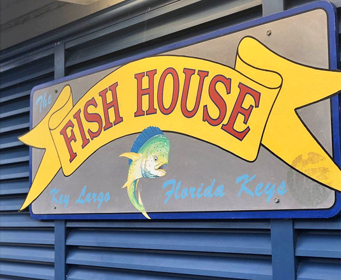 This cheerful sign promises exactly what awaits inside—a genuine Florida Keys seafood experience that lives up to its colorful billing.