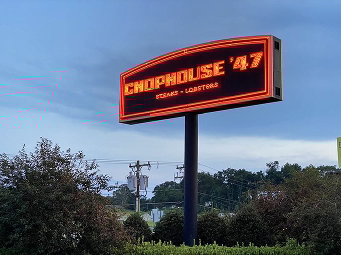 The neon sign glows against the twilight sky, a beacon for beef lovers that simply states: steaks and lobsters &ndash; no further explanation needed.