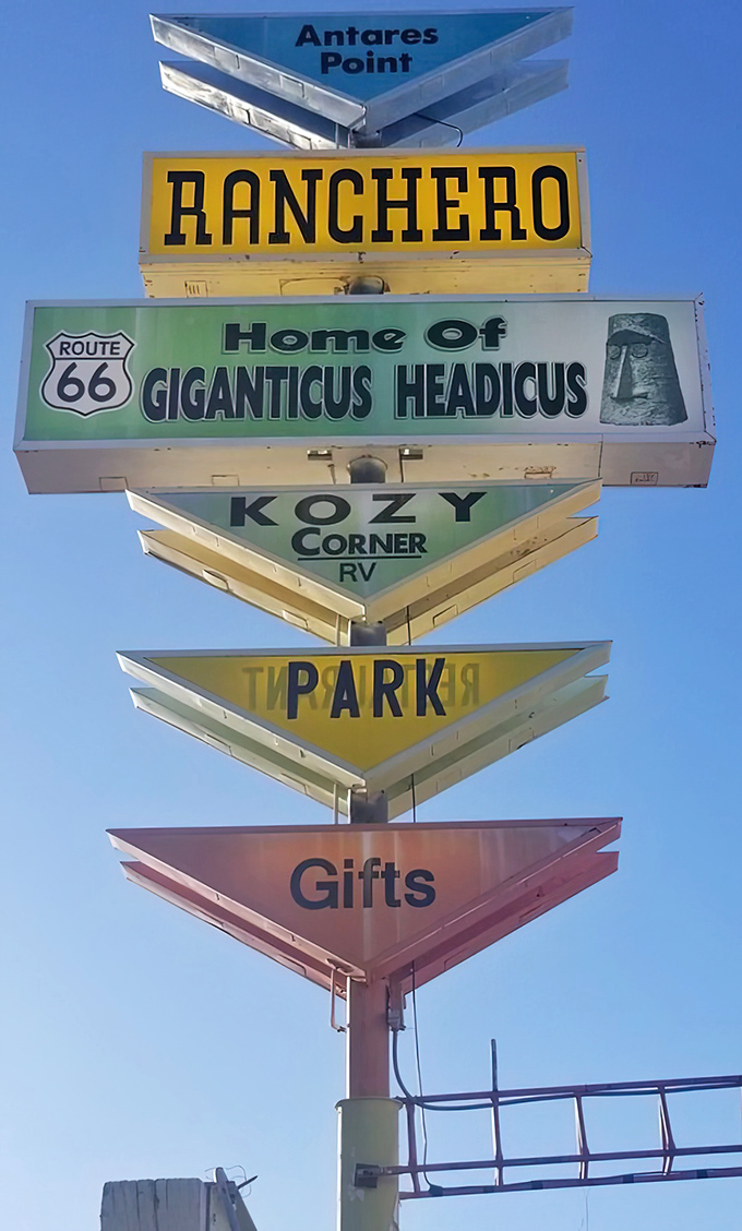 The multi-layered sign tower serves as a roadside resume&mdash;"Home of Giganticus Headicus" being the most impressive qualification on its colorful CV.