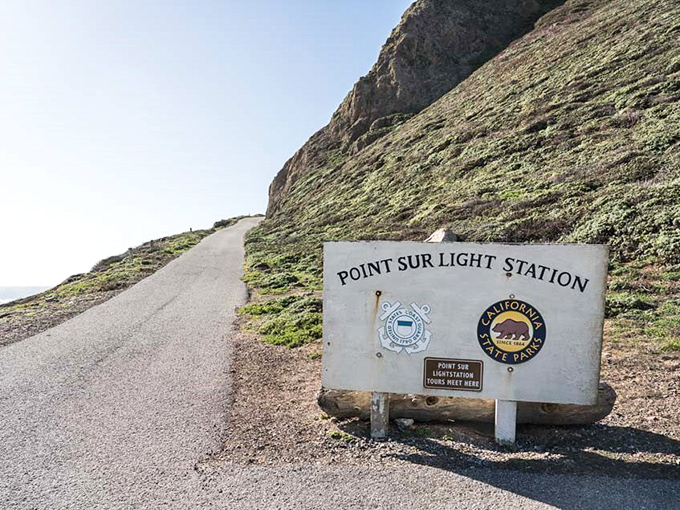 The winding path to adventure begins here, where a simple sign marks the start of a journey back in time.