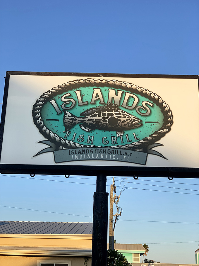 The roadside sign promises "Fish with an Attitude" against the Florida sky&mdash;a bold claim the kitchen consistently backs up with every plate.