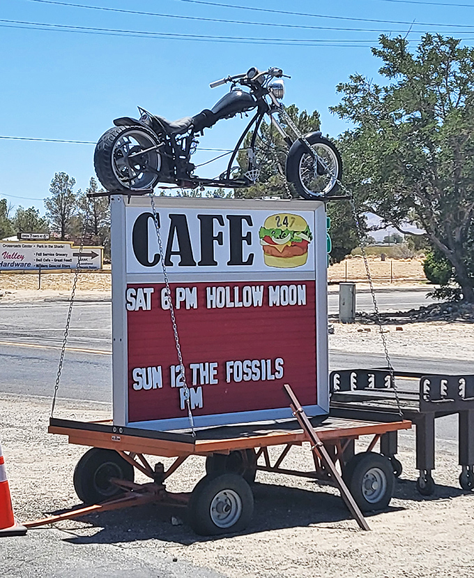 A motorcycle riding high above burger promises. This roadside sign doesn't just advertise food&mdash;it announces an experience worth the detour.