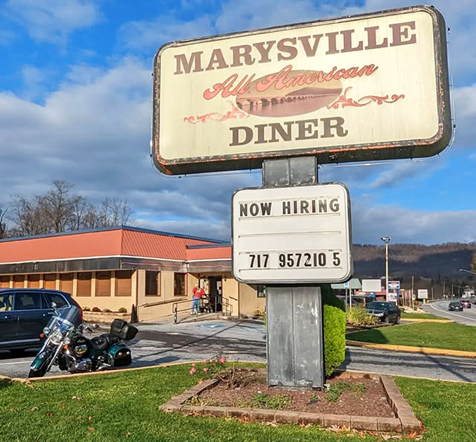 The sign promises "All American" and delivers exactly that&mdash;no pretension, just honest food and the promise of a full stomach.