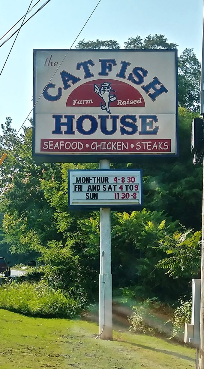 The roadside sign promises "Farm Raised" seafood and posts hours that feel like an invitation to the best kind of gathering.