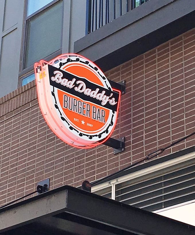 The neon sign glows like a burger lighthouse, guiding hungry souls to their delicious destination with retro-cool confidence.