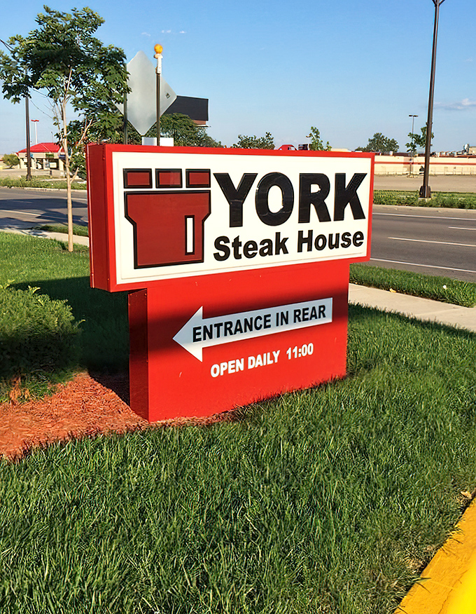 The bold red signage announces York's presence with no-nonsense confidence, directing hungry visitors to the entrance with the straightforward approach that defines everything about this beloved steakhouse.