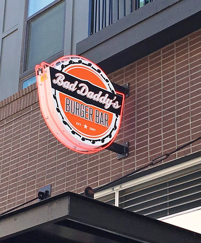 The neon sign glows like a burger lighthouse, guiding hungry souls to their delicious destination with retro-cool confidence.