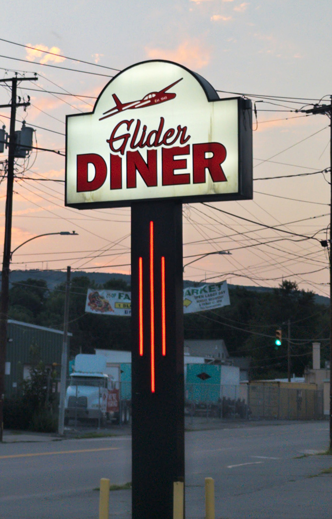 As evening falls, the illuminated sign glows like a promise. In a world of constant change, there's something deeply reassuring about a diner that endures.