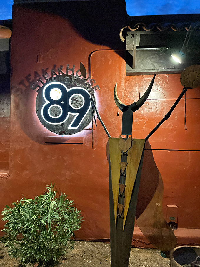 The glowing 89 sign stands sentinel beside Southwestern art, beckoning hungry travelers like a carnivorous North Star.