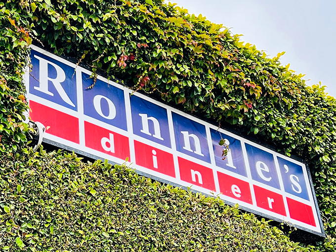 The iconic Ronnie's sign, nestled among greenery, has guided hungry Angelenos to pancake paradise for years.