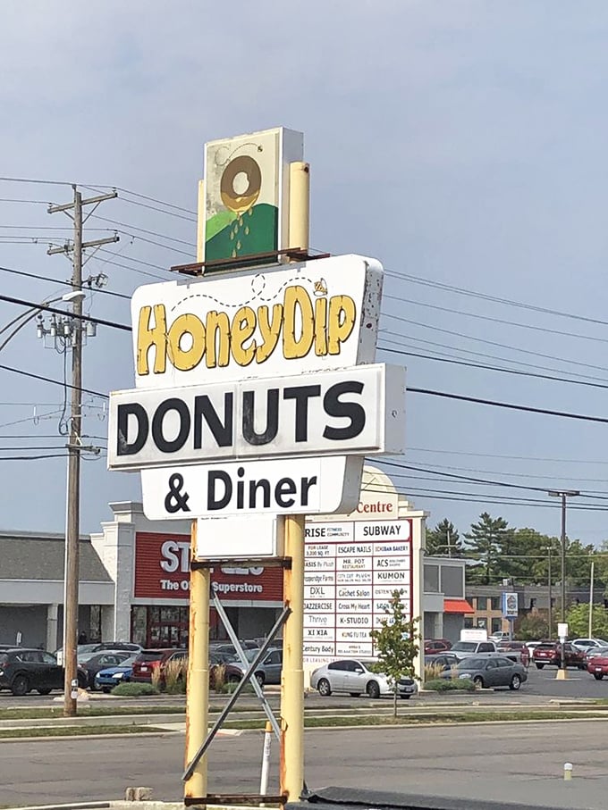 A roadside beacon of hope for the hungry, standing tall among chain restaurants like a sweet reminder of Columbus's independent spirit.