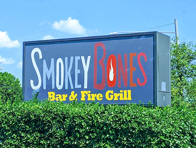 The roadside sign stands as a beacon of hope for the hungry, promising smoky delights just beyond the hedgerow.
