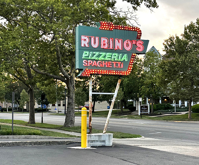 This sign doesn't just mark a restaurant; it's a neon-lit landmark guiding hungry travelers to pizza paradise since the days of black-and-white TV.