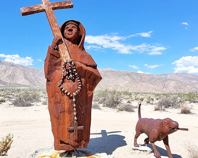 A Spanish padre and his faithful companion stand watch over the desert, their metal forms telling stories of California's complex colonial past.