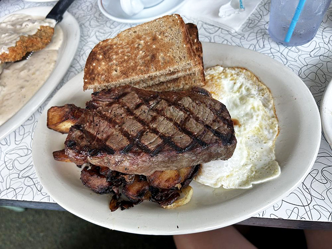 The holy trinity of diner breakfasts: a perfectly grilled steak, eggs with molten yolks, and toast ready to soak up all that runny gold.
