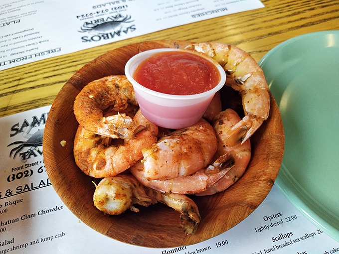 Plump steamed shrimp in a wooden bowl with cocktail sauce&mdash;simple, unpretentious, and exactly what seafood should be.