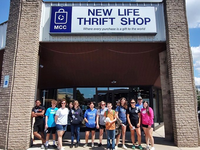 Happy shoppers gather outside this treasure trove, proving that bargain hunting creates genuine community connections.