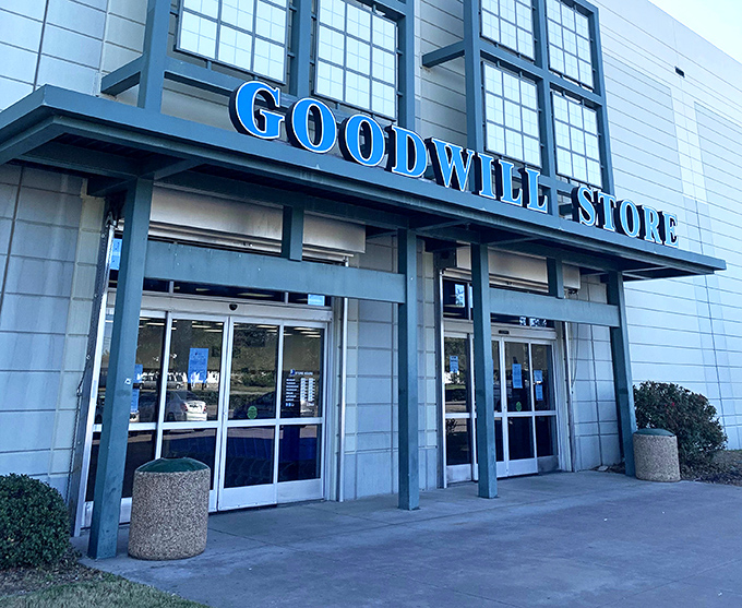 The blue beacon of bargains beckons from the roadside, promising adventures in secondhand splendor within.