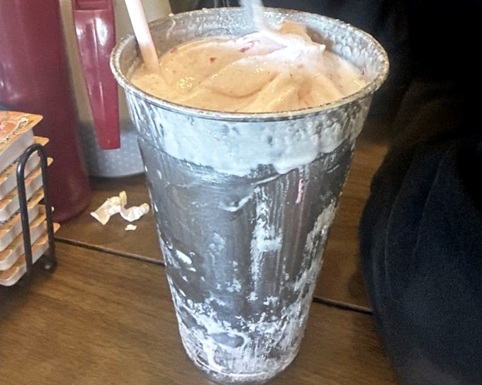 This isn't just a milkshake; it's a frosty monument to dairy excellence so thick the straw stands at attention like a soldier on guard duty.
