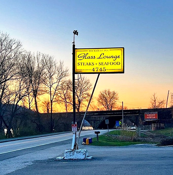 At sunset, the Glass Lounge sign glows like a lighthouse for the hungry. A Pennsylvania landmark that's guided flavor-seekers to safe harbor for generations.