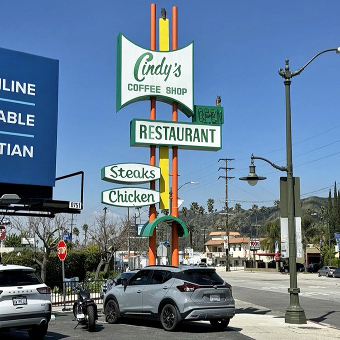 This vintage street sign stands as a beacon for breakfast pilgrims seeking the ultimate French toast experience.