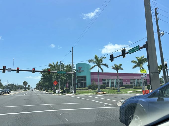 Even from the street, that distinctive turquoise and pink building stands out against Florida's blue sky. Palm trees complete the perfect St. Petersburg scene.