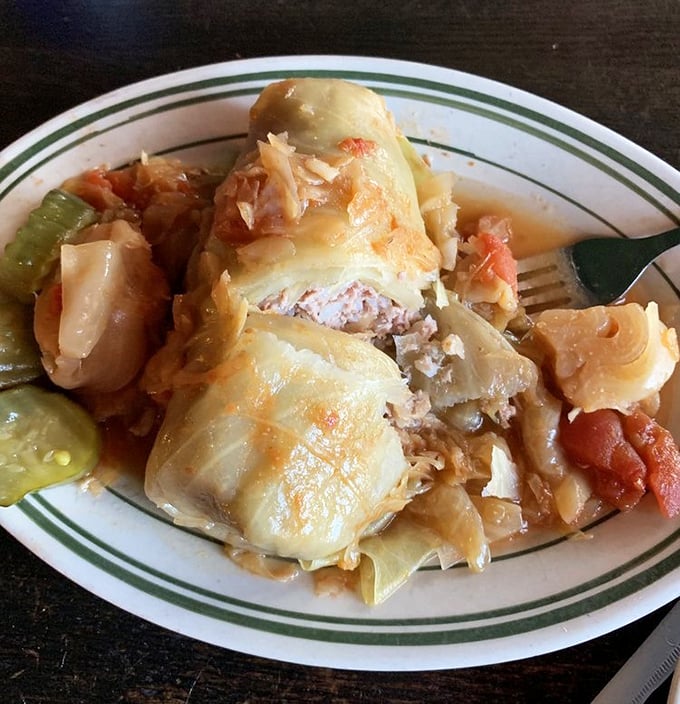 Stuffed cabbage rolls nestled together like delicious little sleeping bags filled with meaty dreams and Hungarian tradition.