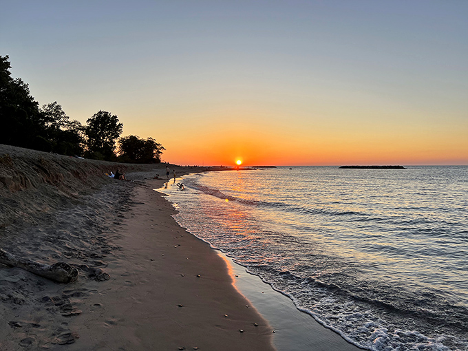 The grand finale: a Presque Isle sunset paints the sky in impossible oranges and pinks, silencing even the most talkative beachgoers.