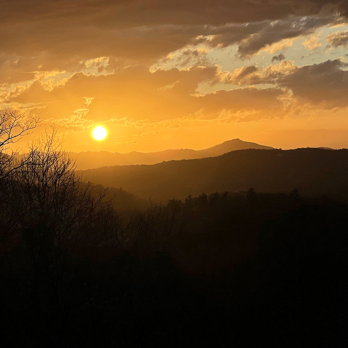 The kind of sunset that makes you believe in magic. Mountains silhouetted against a golden sky remind us why we travel in the first place.