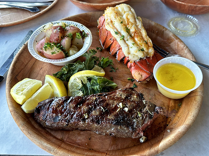 Surf and turf: where land and sea call a delicious truce on your wooden plate. That lobster tail looks like it's trying to escape the steak's gravitational pull.