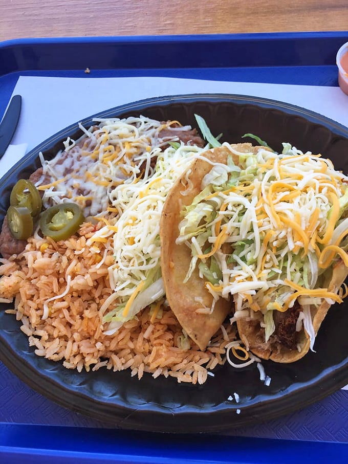 Tacos served with the trilogy of Mexican perfection: rice, beans, and jalape&ntilde;os&mdash;a plate that speaks the universal language of deliciousness.