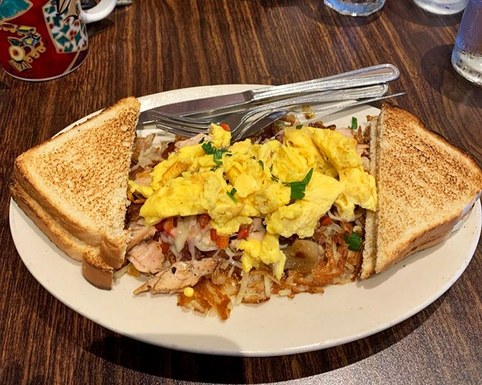 When breakfast sandwiches dream at night, they dream of becoming this masterpiece—eggs nestled on a bed of savory hash, flanked by perfectly toasted bread.