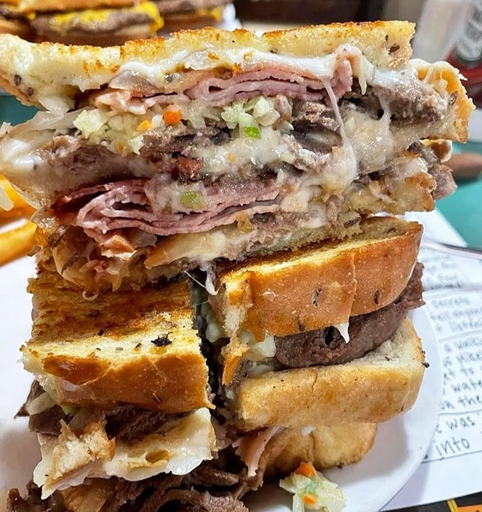 Behold the skyscraper of sandwiches! Layers upon layers of meats and cheese create an edible monument to excess that would make any cardiologist nervous.