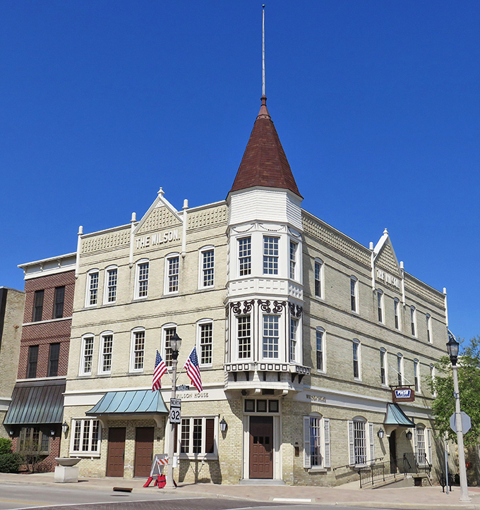 The Wilson House stands as a cornerstone of downtown, its distinctive turret and ornate details showcasing the prosperity of Port Washington's earlier days. Those American flags aren't just patriotic – they're practically mandatory in small-town Wisconsin.