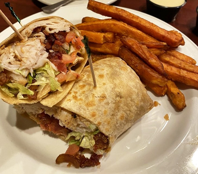 A wrap that refuses to be the boring option on the menu. Those sweet potato fries aren't sidekicks&mdash;they're co-stars in this lunch production.