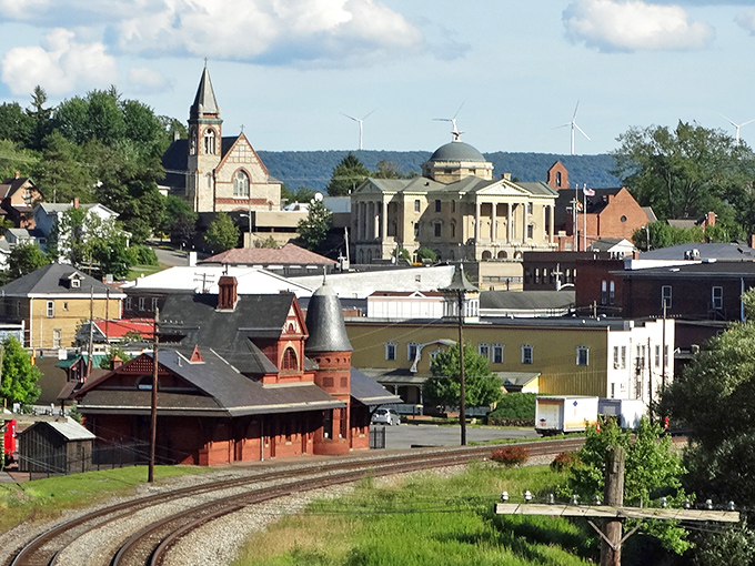 A town nestled among hills and history, where church steeples still compete with trees for who can reach highest.