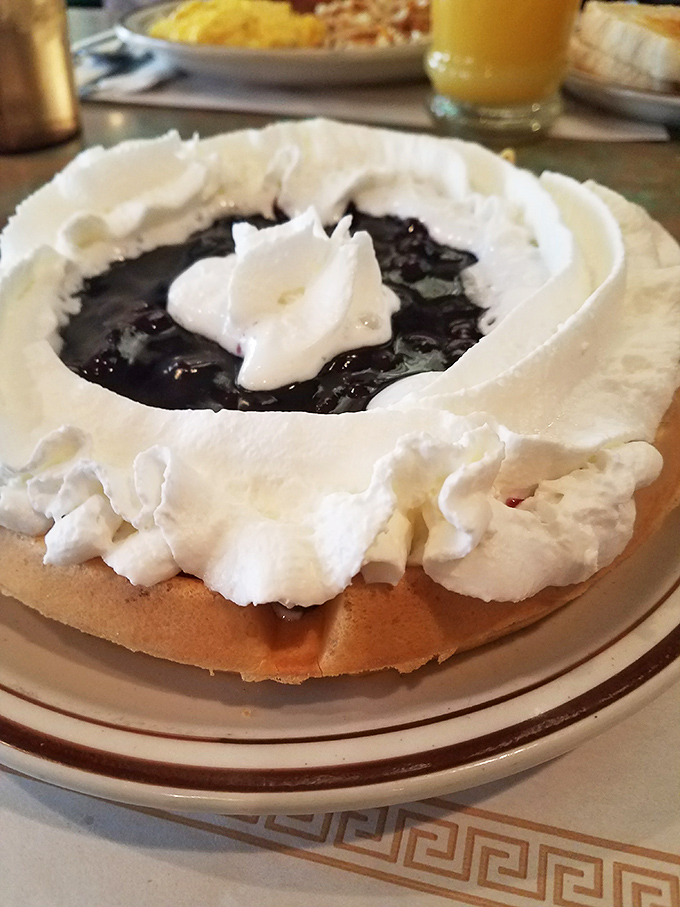 A blueberry waffle crowned with whipped cream&mdash;proof that sometimes the simplest pleasures are the most profound. Breakfast or dessert? Yes, please.