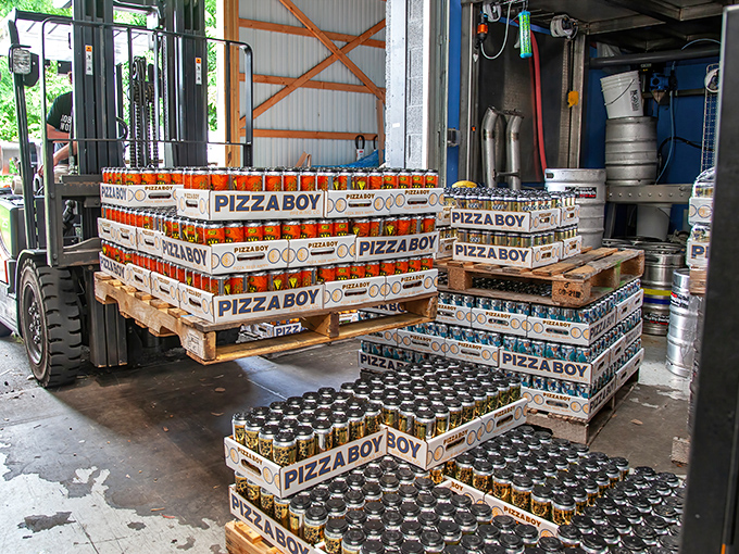 Behind the scenes of beer magic. Those stacked cans aren't just inventory—they're liquid treasures waiting to make someone's day better.