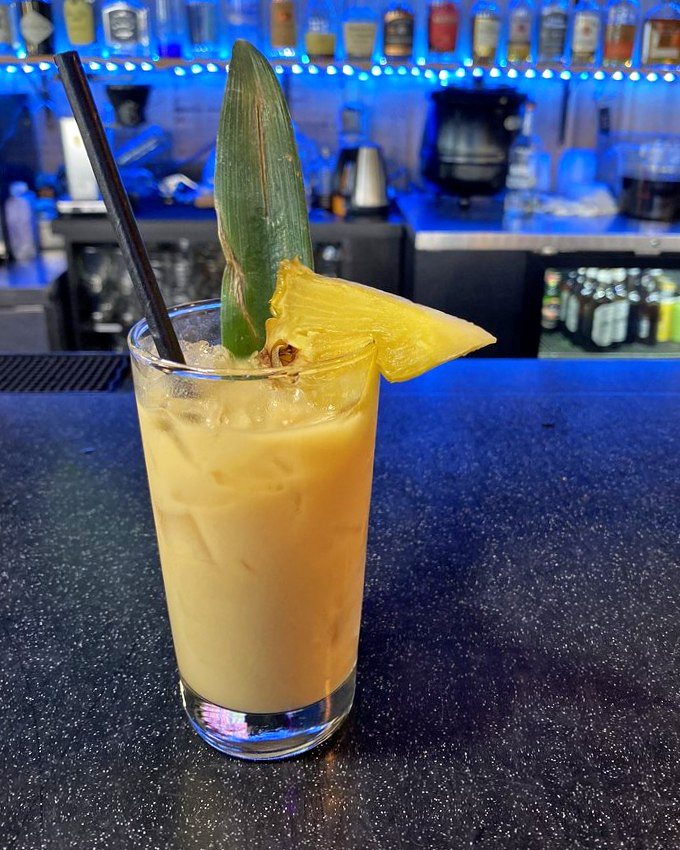 This tropical cocktail isn't just a drink—it's a vacation in a glass. The pineapple garnish is basically a tiny umbrella for your taste buds.