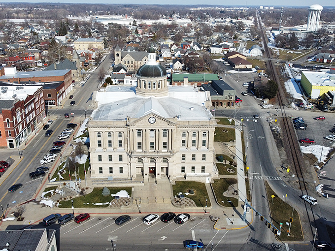 The courthouse stands as Huntington's crown jewel, its dome gleaming above the town like a beacon of small-town democracy in action.