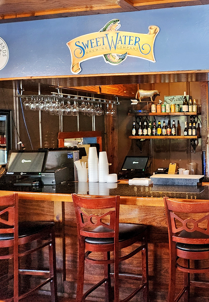 A bar setup that understands priorities: good drinks, comfortable seating, and the promise of conversation that flows as smoothly as the beverages.