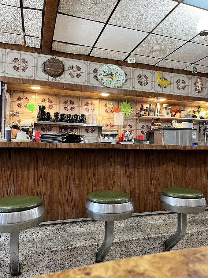 The counter where breakfast dreams come true, complete with vintage stools that have supported generations of happy eaters.